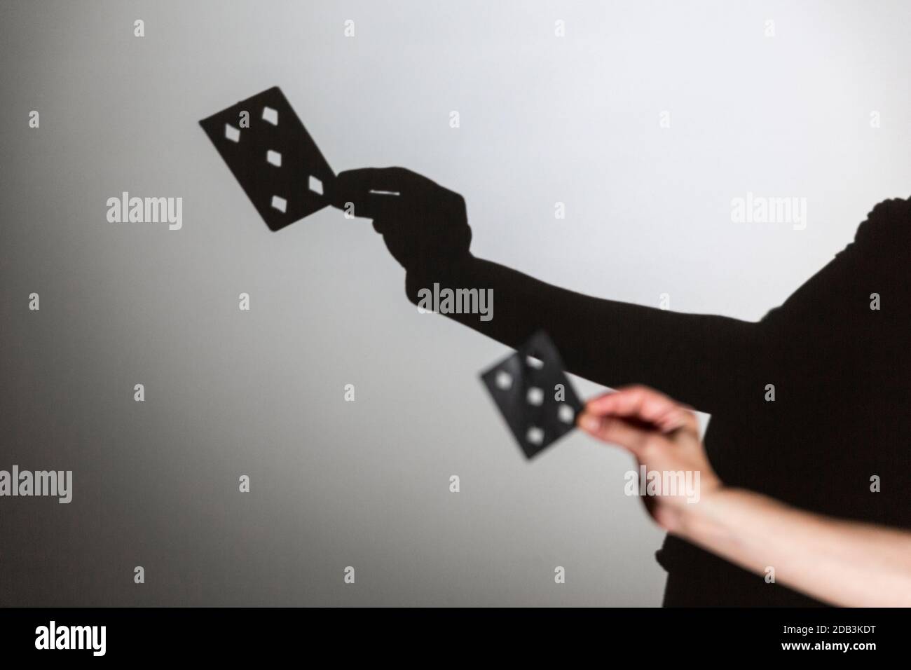 play shadow projected on a white screen. the person's hands shape a ...