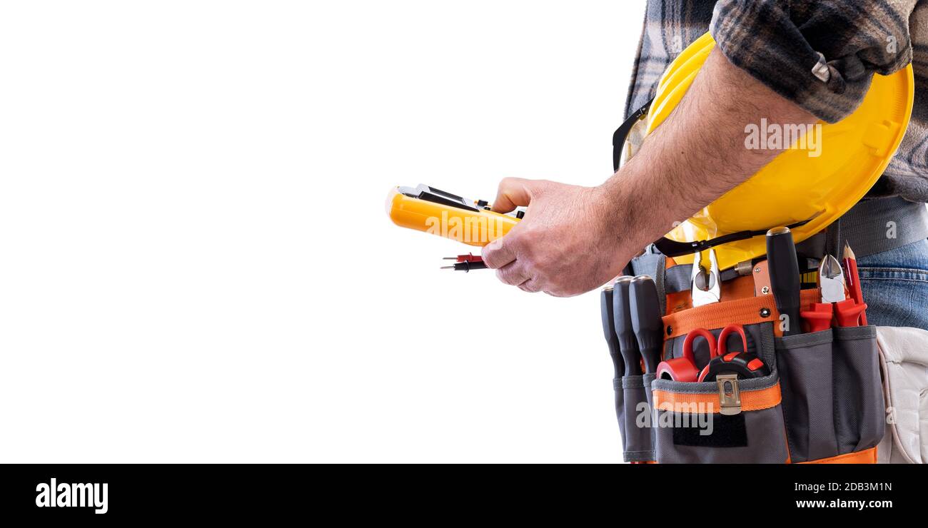 Electrician holds multimeter tester in hand, helmet with protective ...