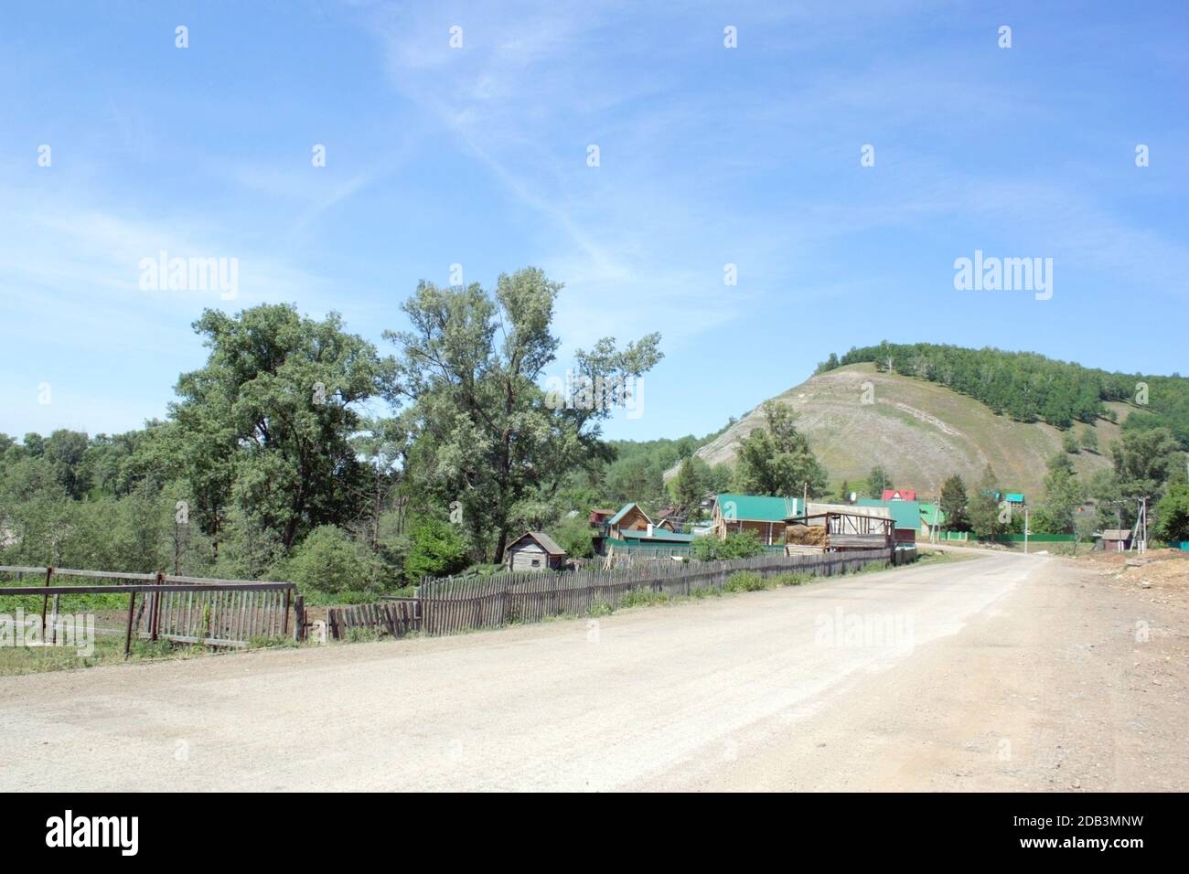 Summer village landscape with high mountain Stock Photo - Alamy