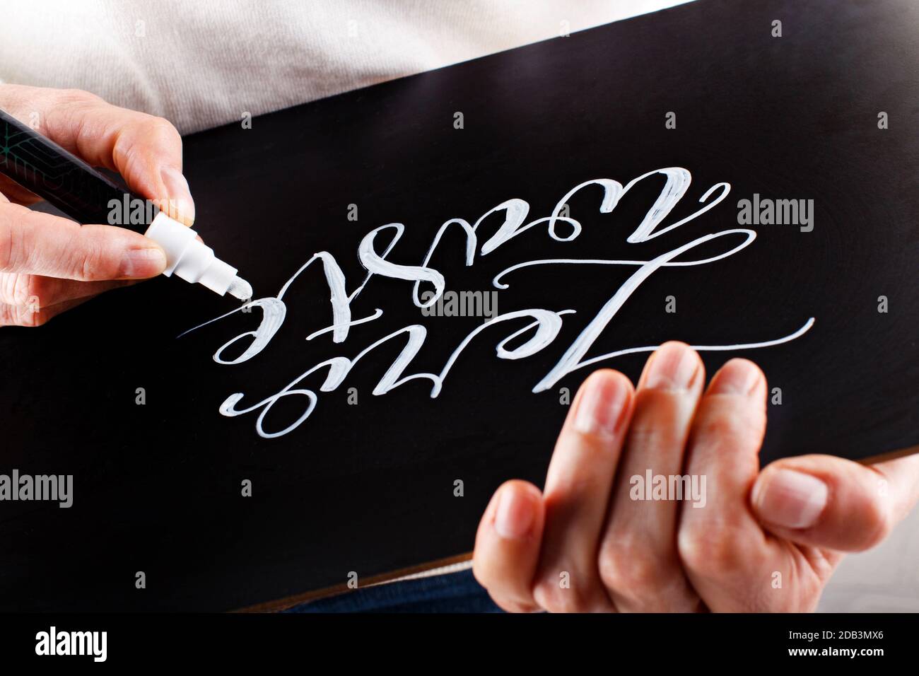 Woman writing on a small chalkboard zero waste lettering close up Stock ...