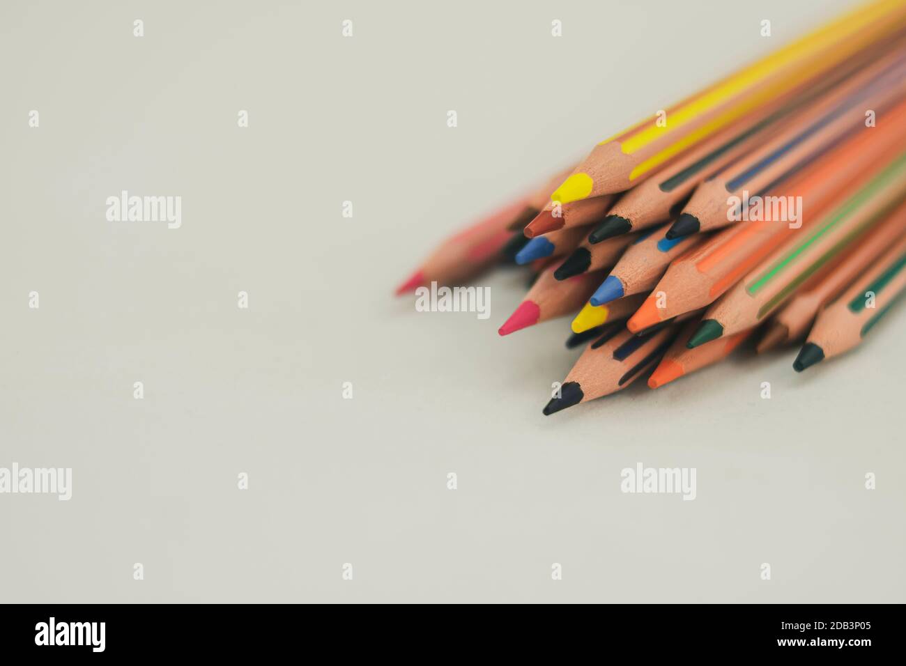 Multiple pencils of different colors to draw, stacked on a white ...