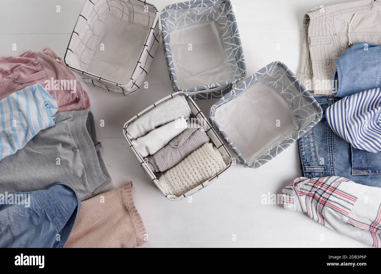 A group of organic cotton clothing set on a white table is ready to be ...