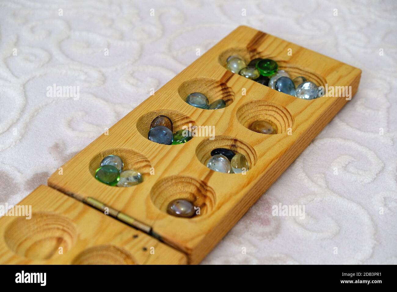 old intelligence games, wooden mancala game, a person playing mancala ...