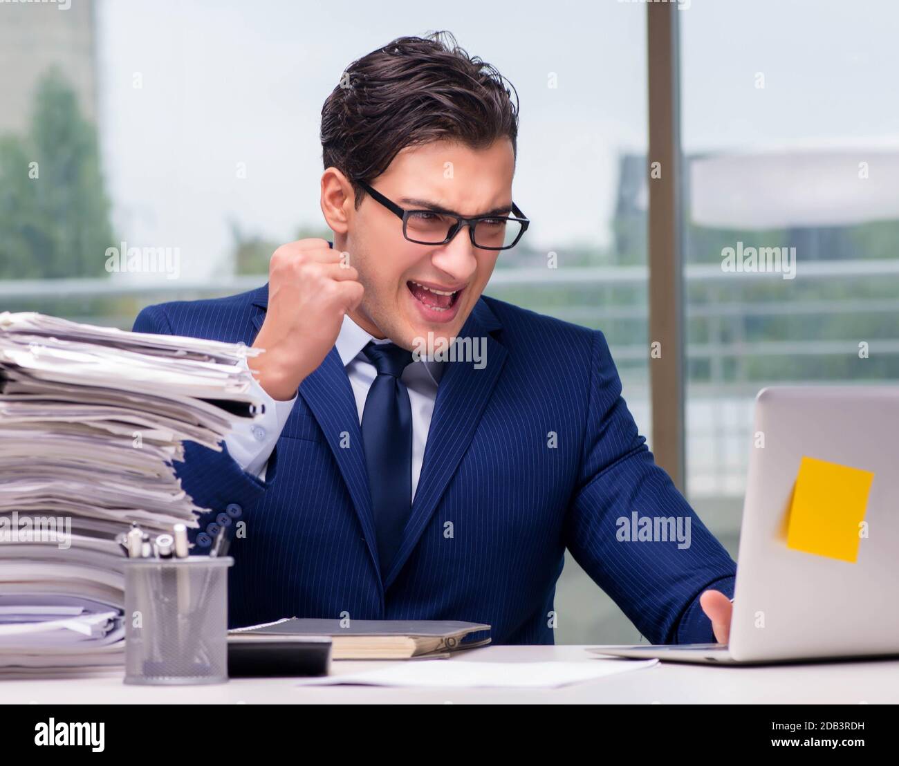 The workaholic businessman overworked with too much work in office ...