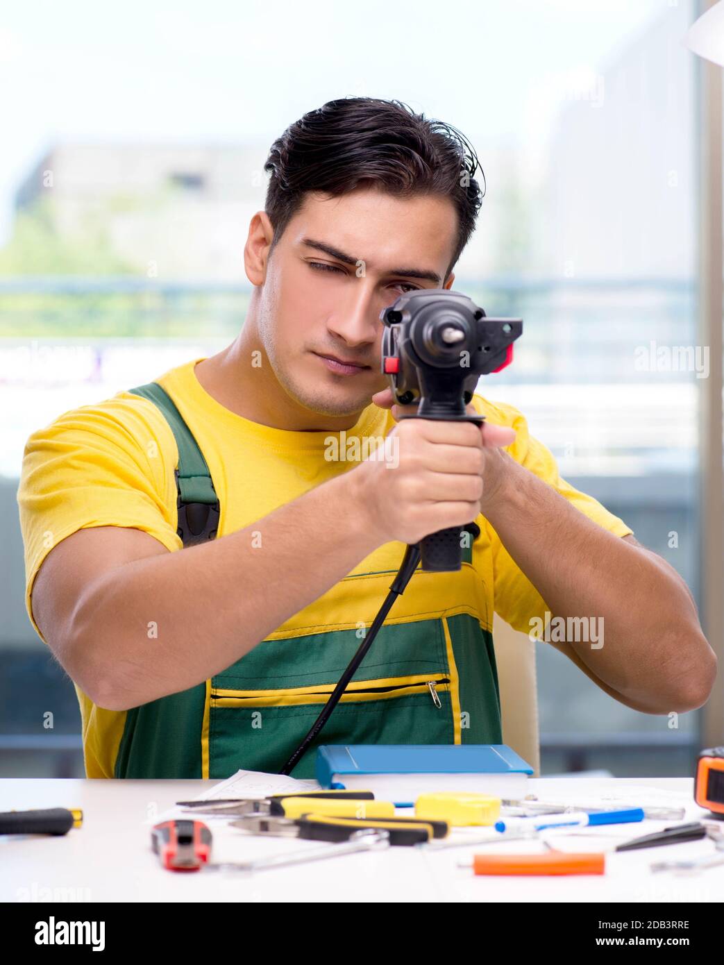 The construction worker sitting at the desk Stock Photo - Alamy
