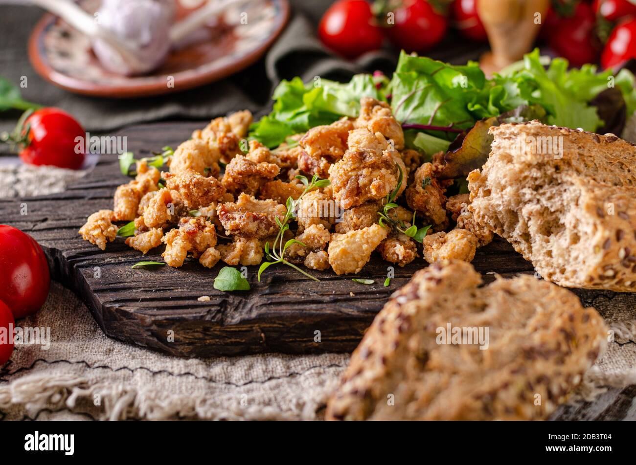 Delicious fat food, fried greaves pork with garlic Stock Photo - Alamy