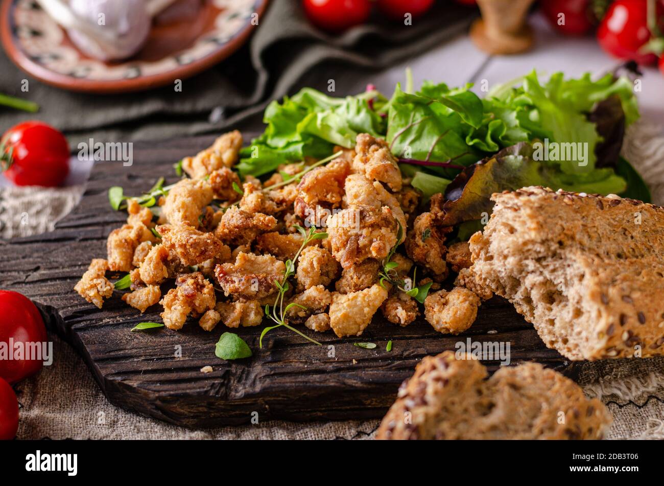 Delicious fat food, fried greaves pork with garlic Stock Photo - Alamy