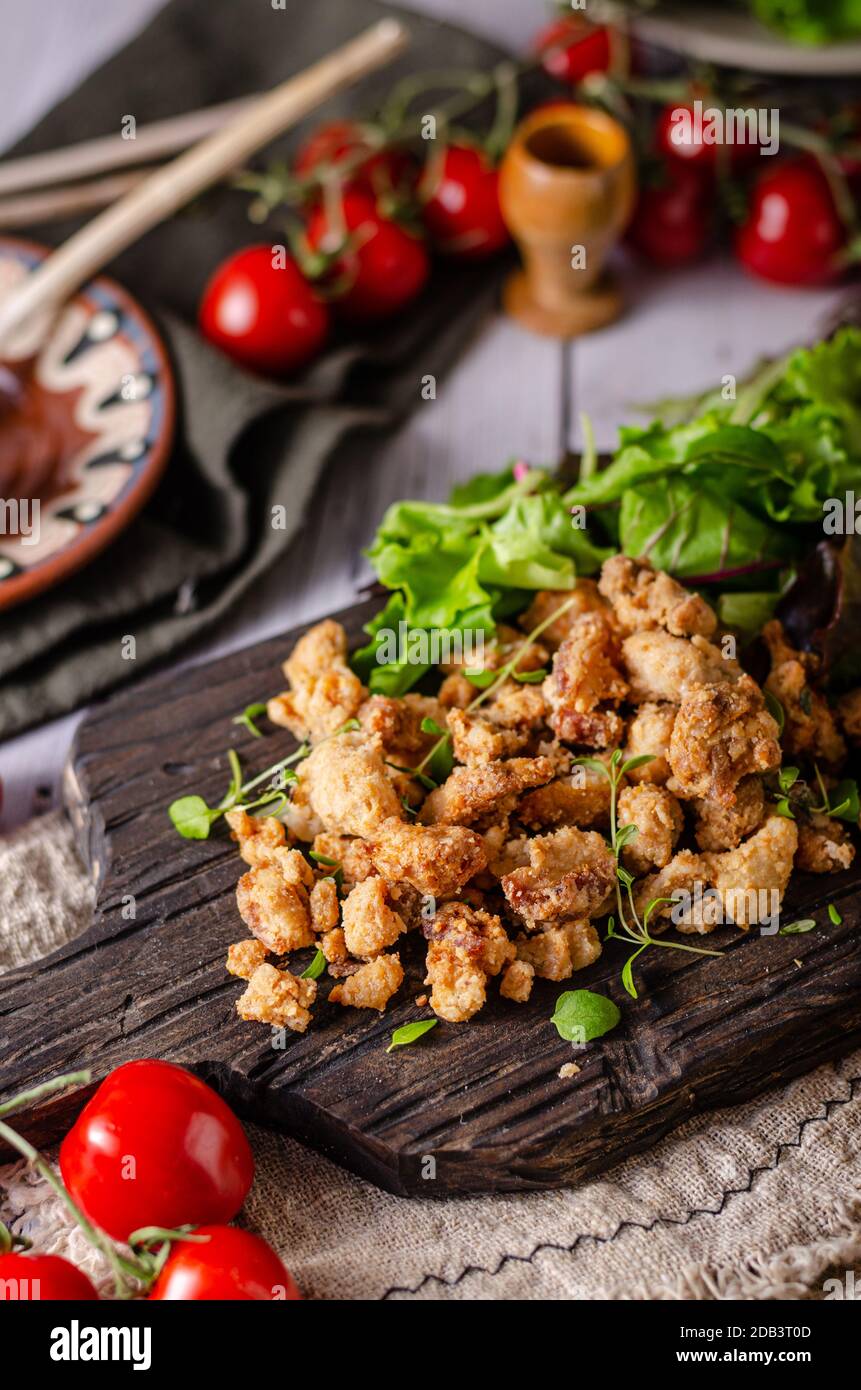 Delicious fat food, fried greaves pork with garlic Stock Photo - Alamy