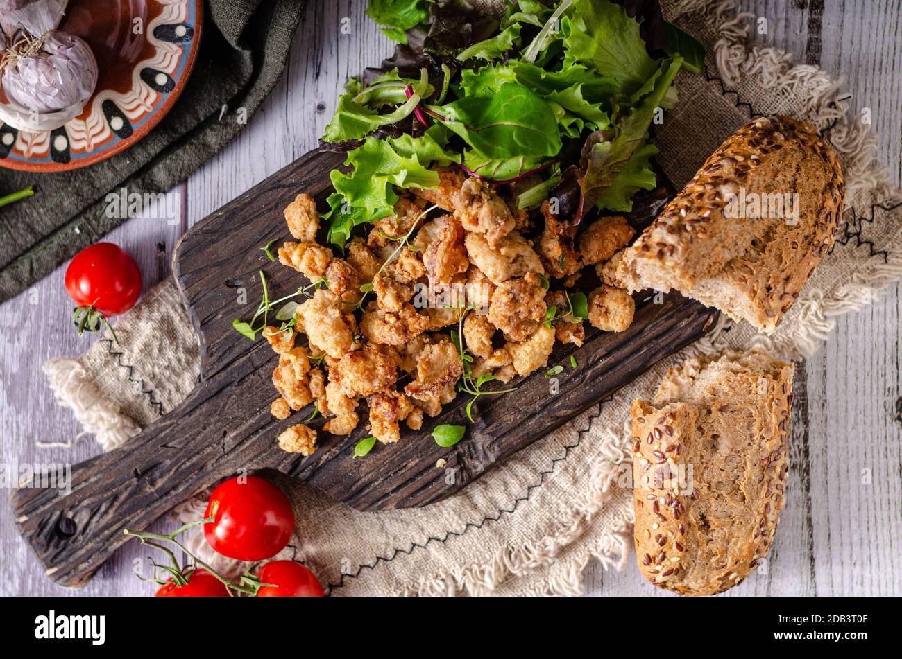 Delicious fat food, fried greaves pork with garlic Stock Photo - Alamy