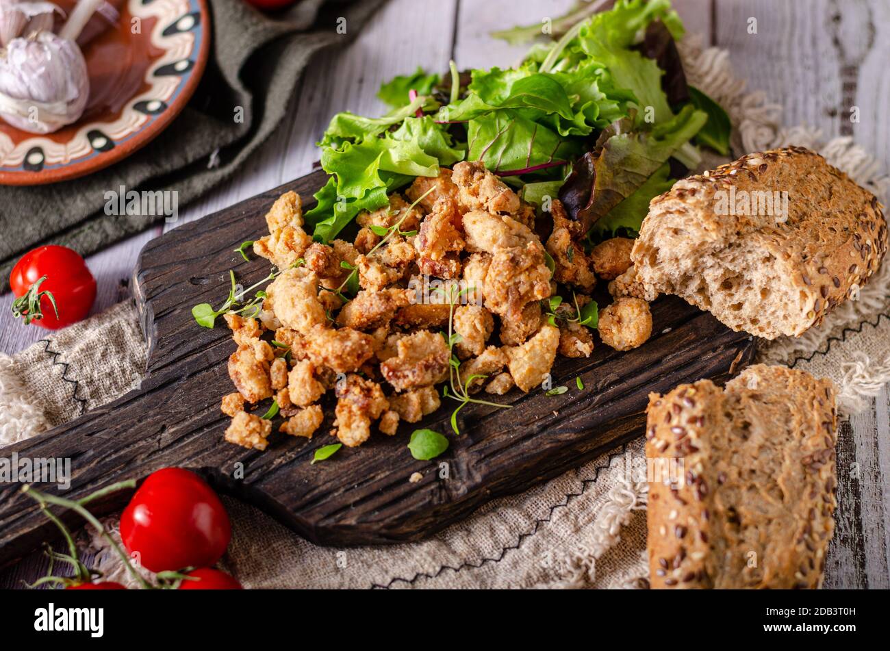Delicious fat food, fried greaves pork with garlic Stock Photo - Alamy