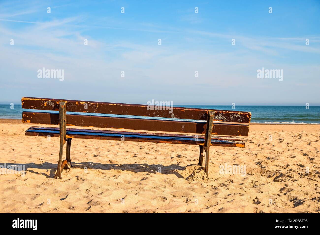 bench on a lonesome beach of the Baltic Sea with blue sky Stock Photo ...