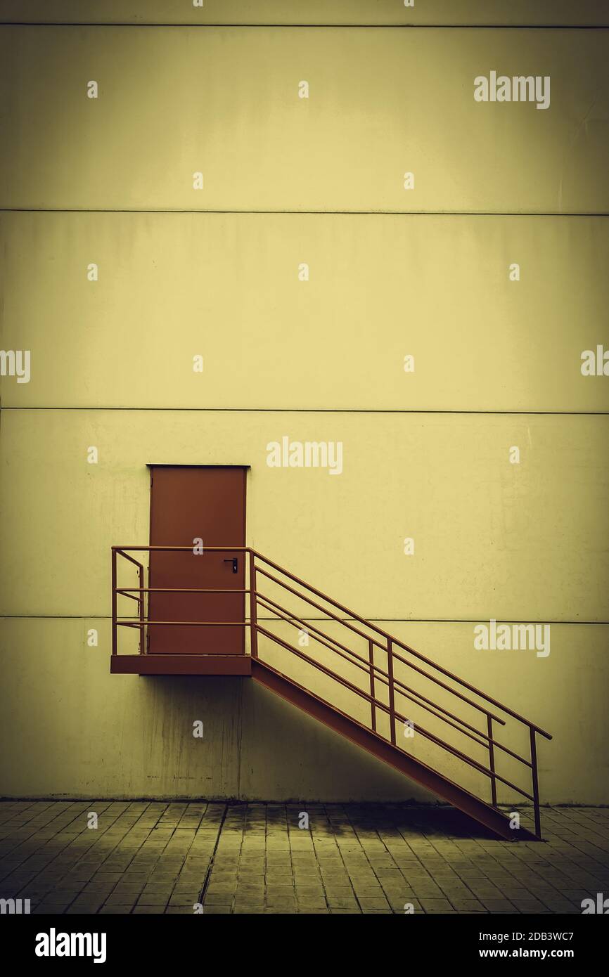 Red metal staircase on the outside, detail of a red painted ladder ...