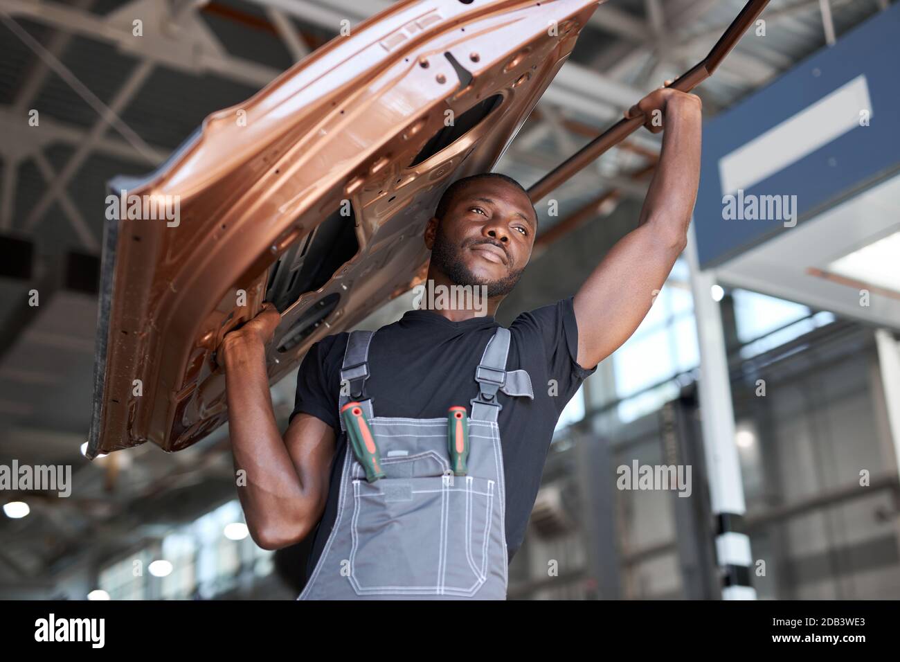 afro american auto mechanic is going to change seperate part of ...