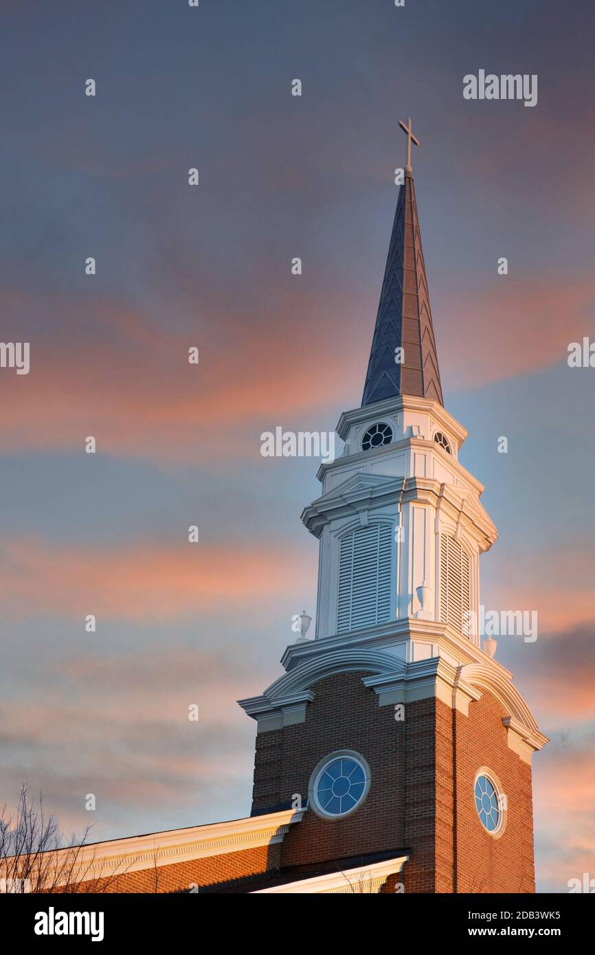 A baptist church steeple rising into a clear blue early morning sky ...