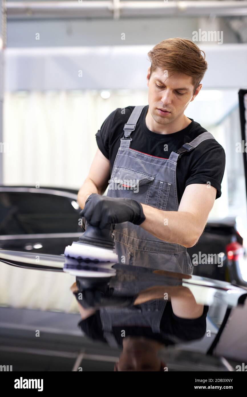 repairing in action. hardworking guy employee in uniform works in the ...