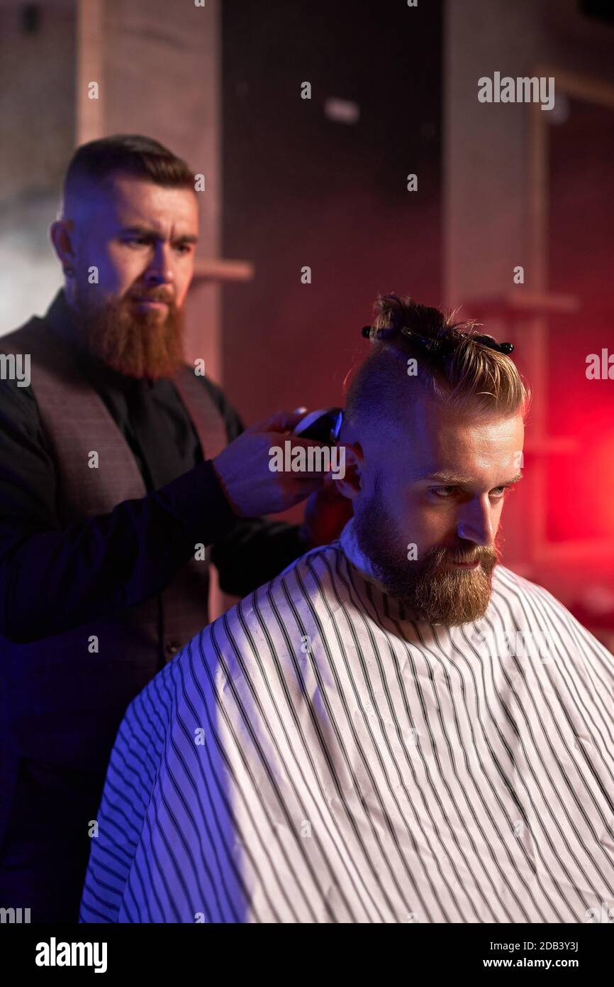 haircut at the hairdresser, in salon. barber male cuts the hair on the ...
