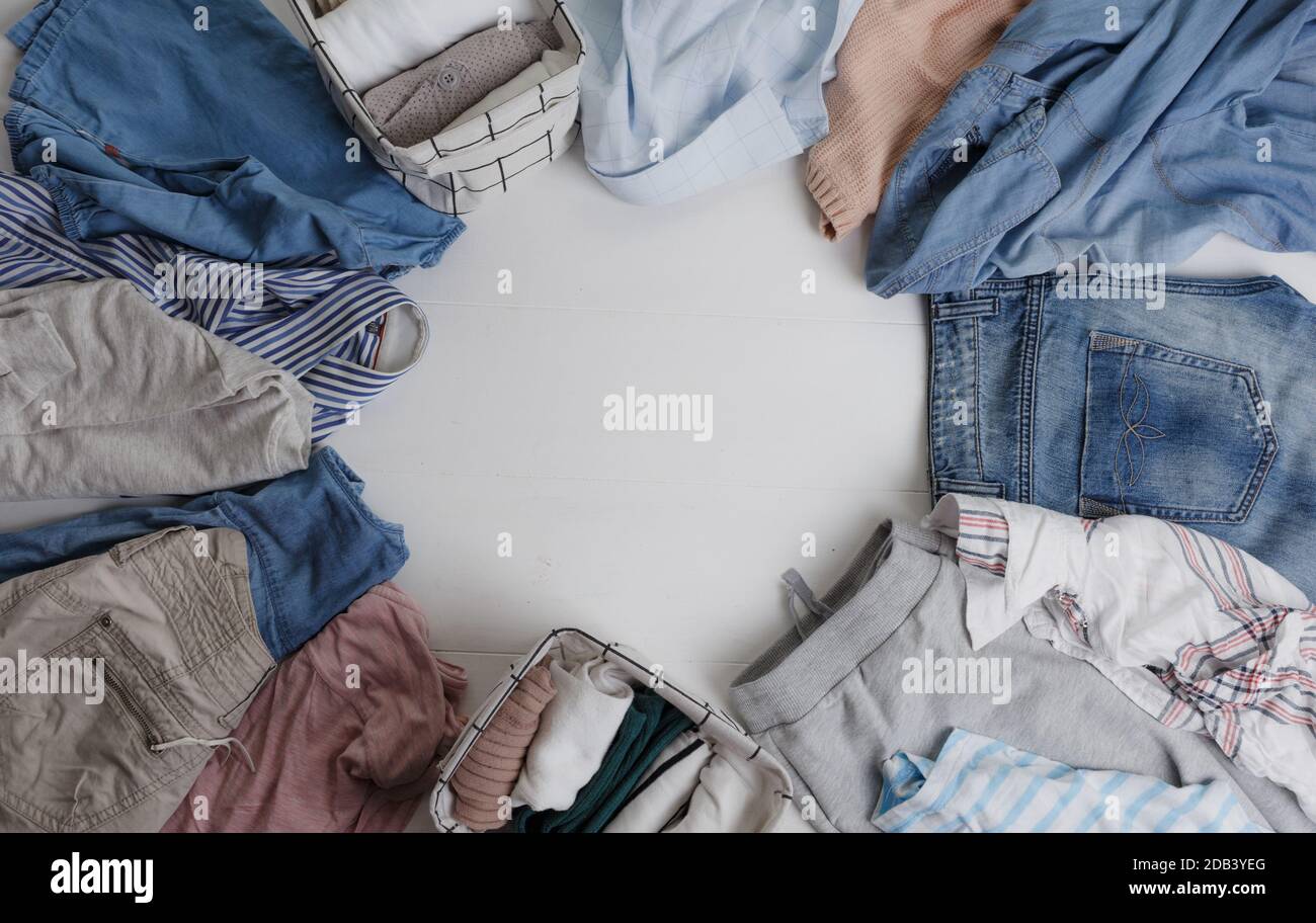 A group of organic cotton clothing laid out on a white table in a ...