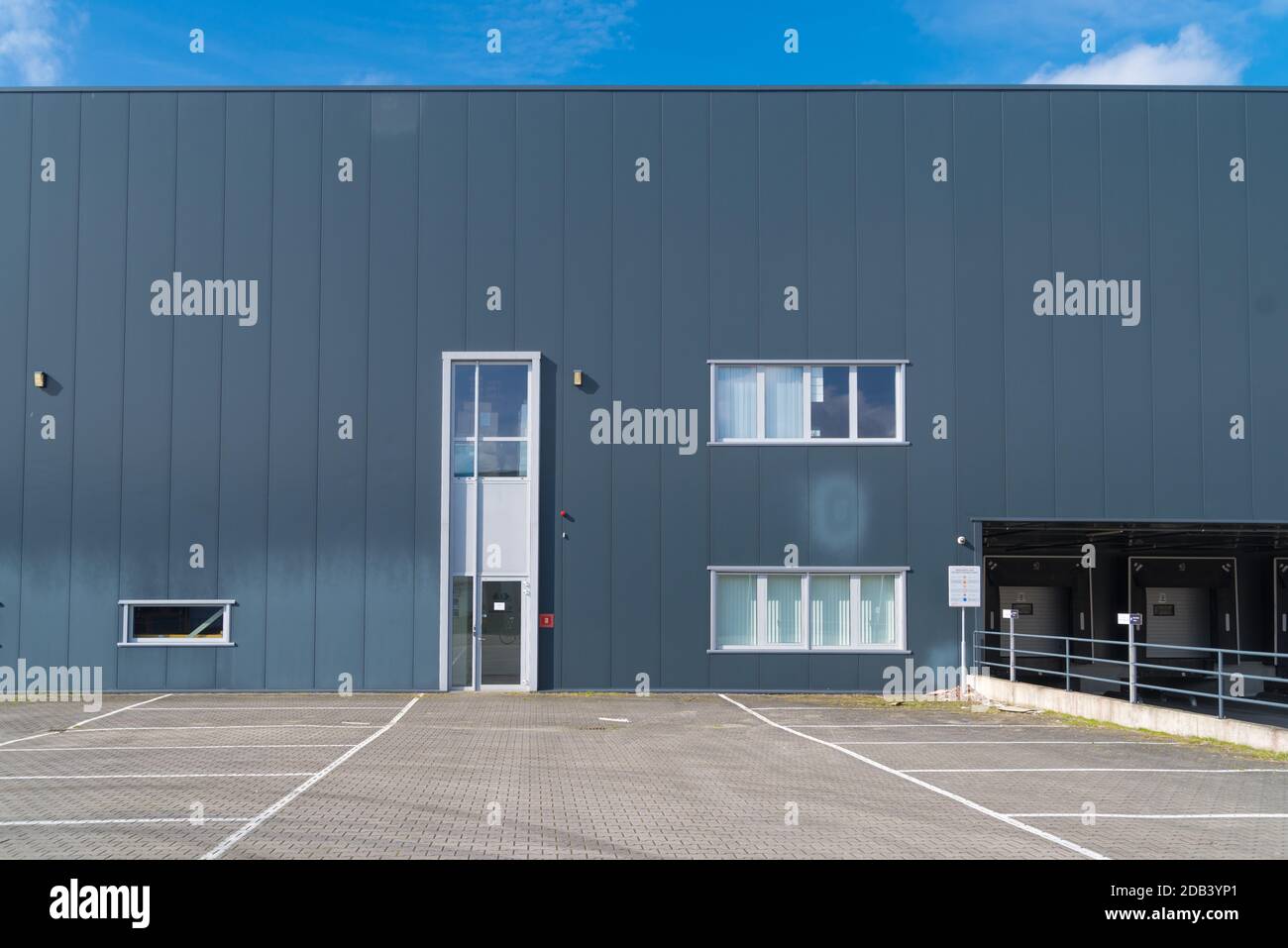 exterior of a large warehouse with loading docks Stock Photo - Alamy