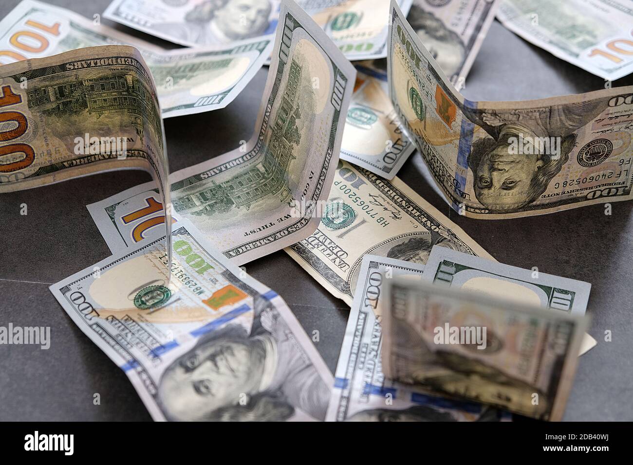 $100 dollars too much standing on a black background, world currency ...