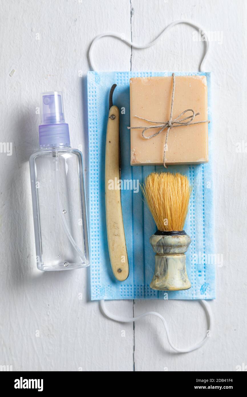 Antique barber equipment with razor, brush and mask in pandemic on ...