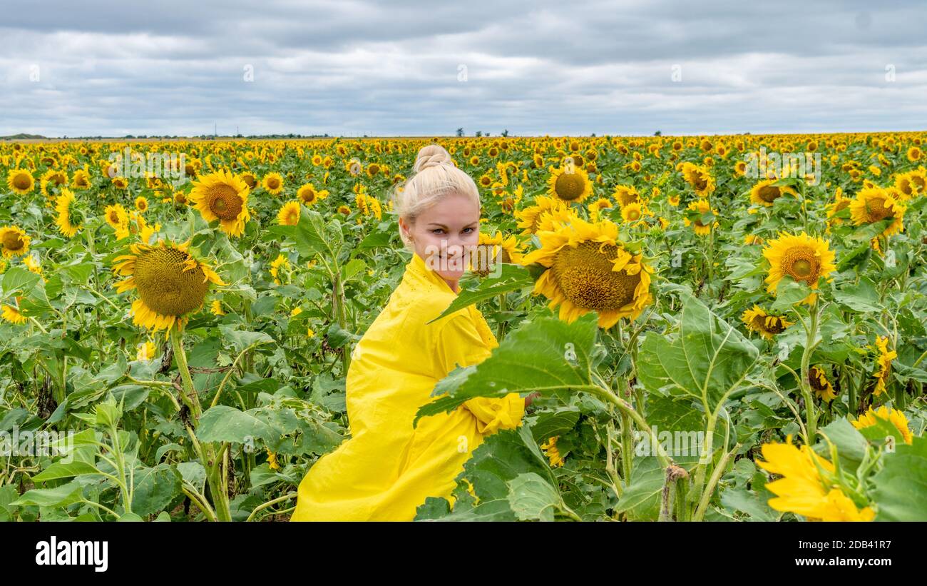 Happy woman in yellow dress with a kind look in hot sunny weather Stock ...