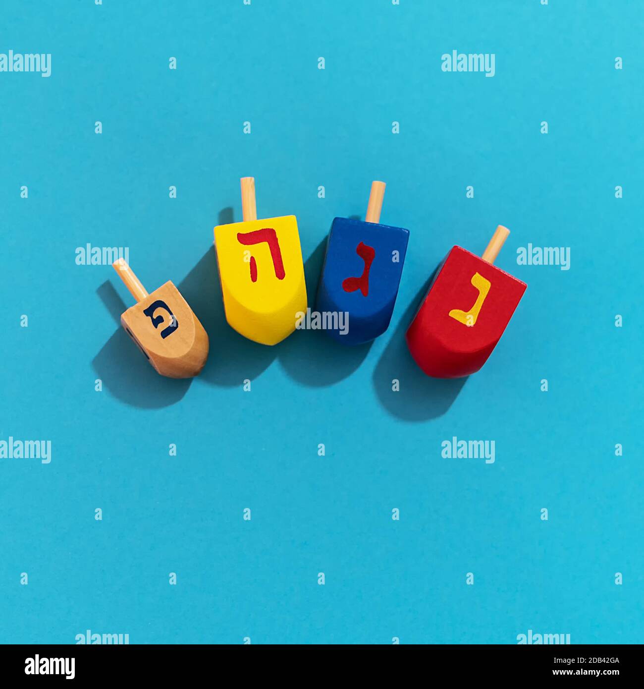 A top view of Hanukkah dreidel in a blue background - a game played ...