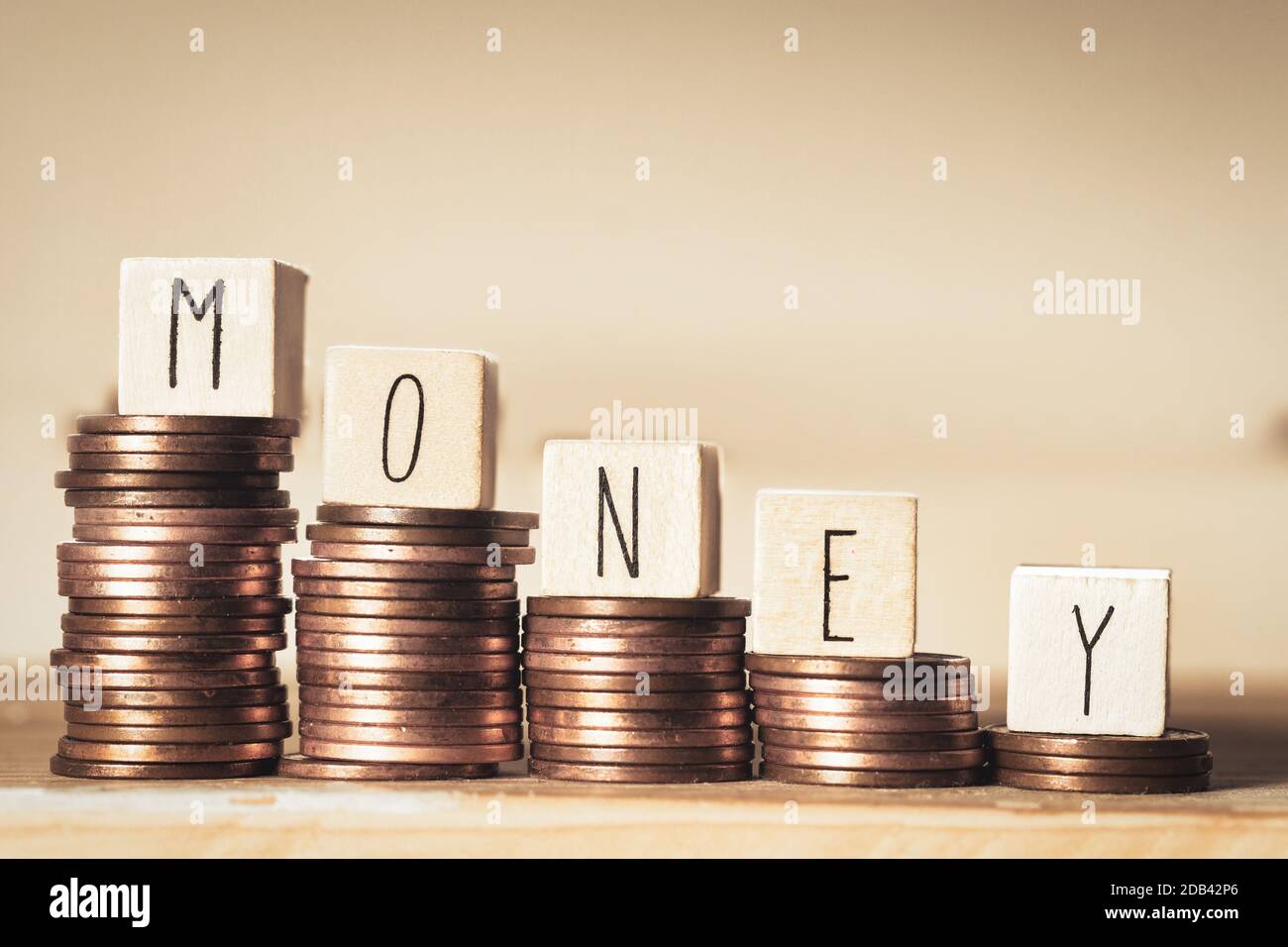 Wooden blocks with the word Money and a pile of coins, Money climbing ...