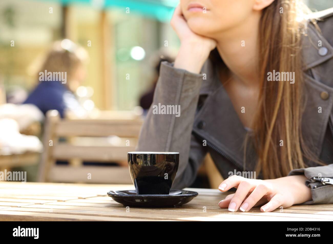 Close up of impatient woman waiting finger tapping on a cafe terrace ...