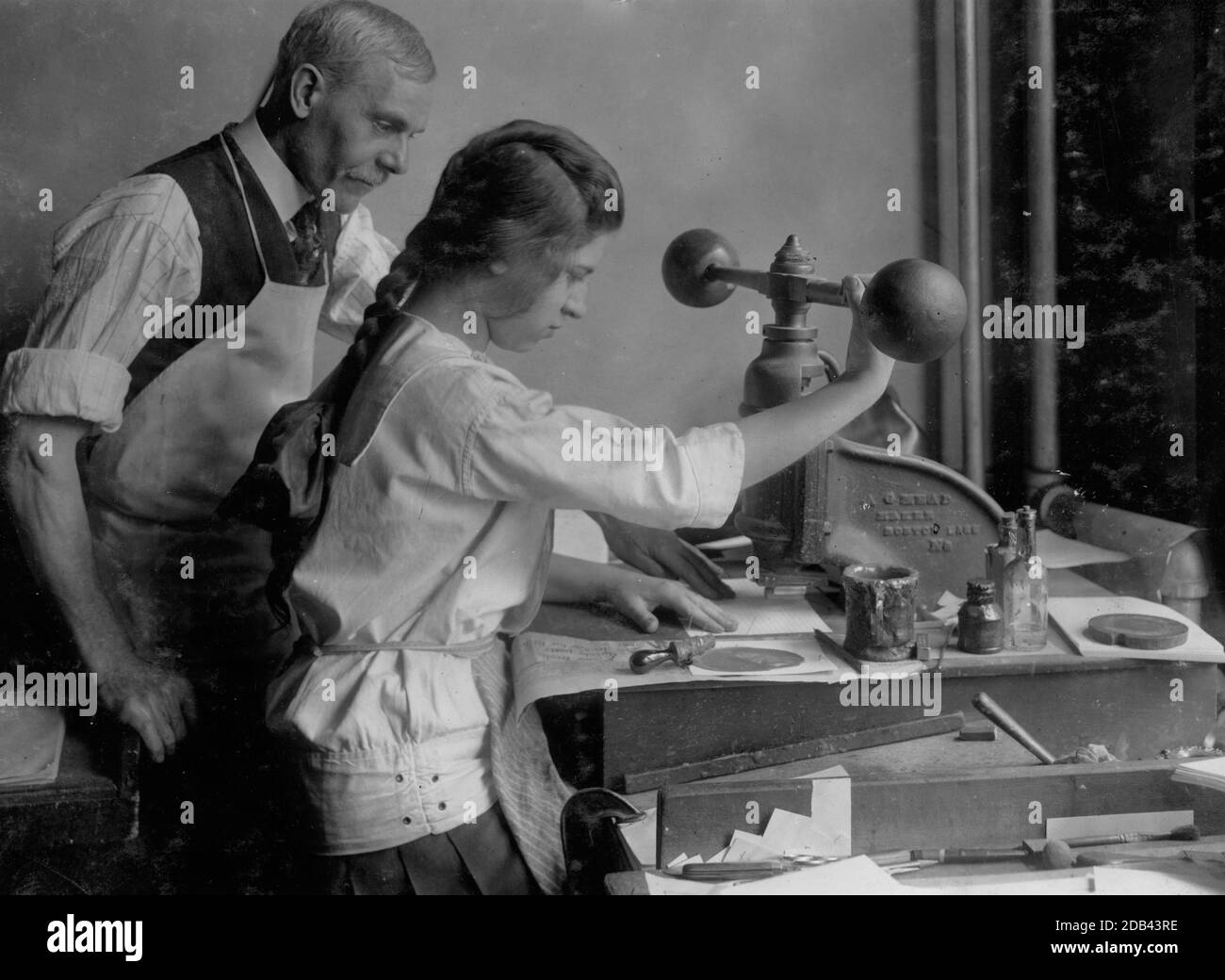 Embossing Press Operator getting Instruction Stock Photo - Alamy