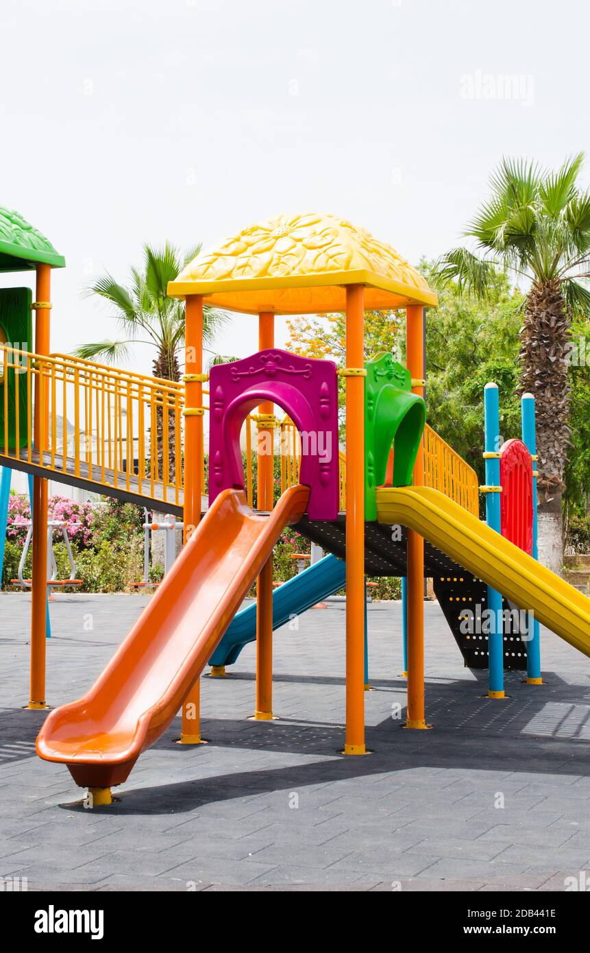 Colorful children playground activities in public park surrounded by ...