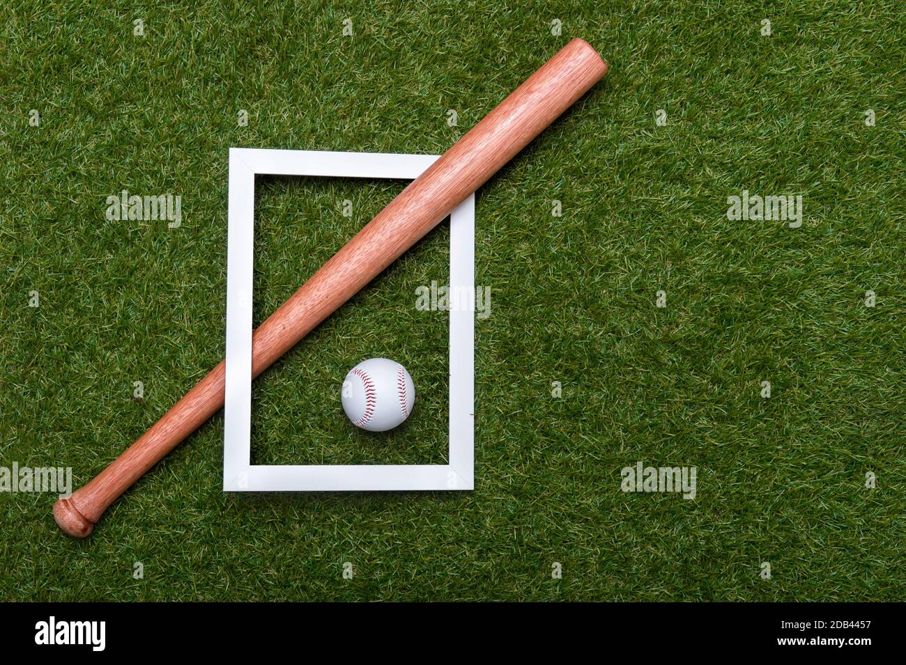 Baseball bat and ball on green grass field. Sport theme background with ...