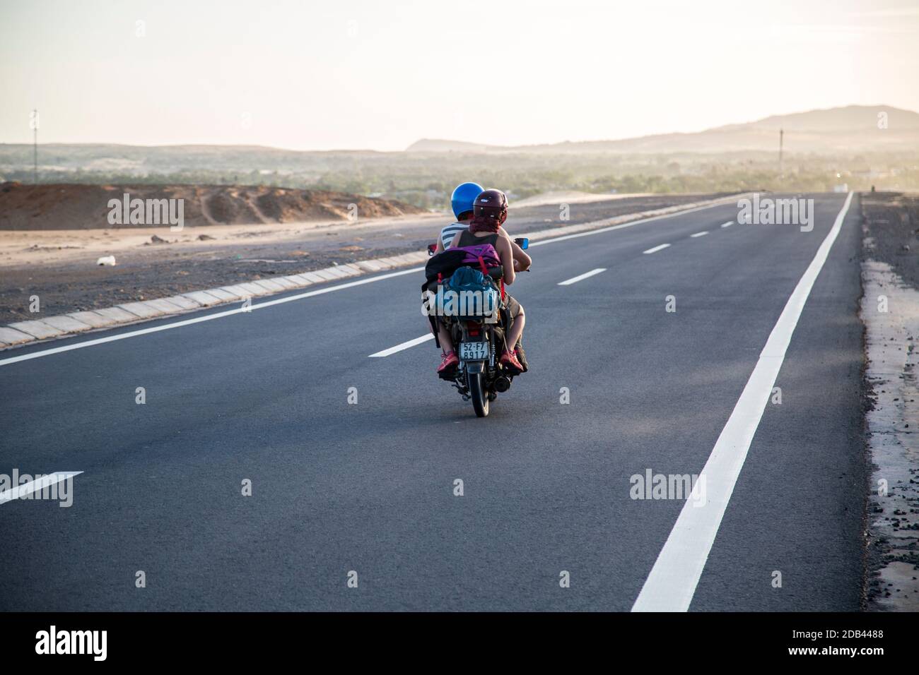 Rear view of young couple riding motorcycle hi-res stock photography ...