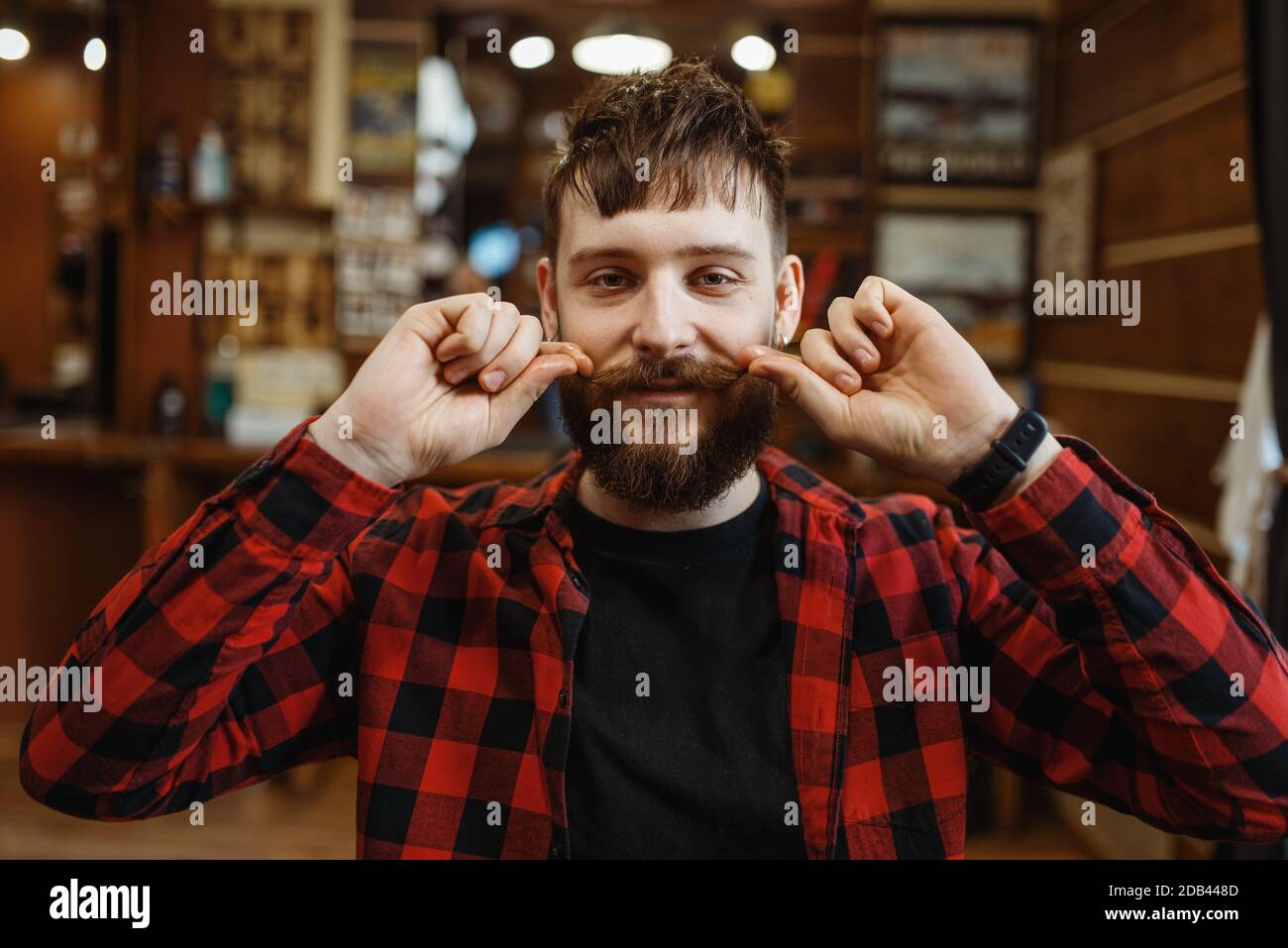 Barber twists his mustache. Professional barbershop is a trendy ...