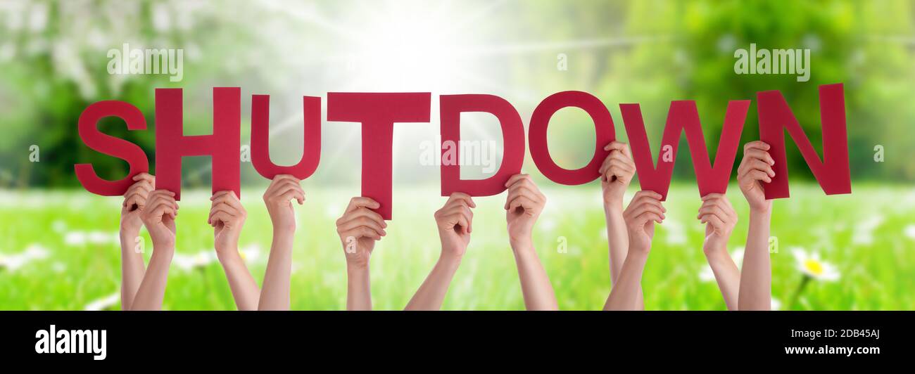 People Hands Holding Colorful English Word Shutdown. Sunny Green Grass ...