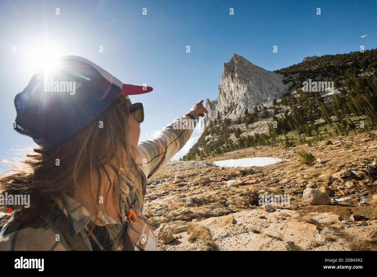 Female hiker pointing at rock formation, Tuolumne Meadows, Yosemite ...