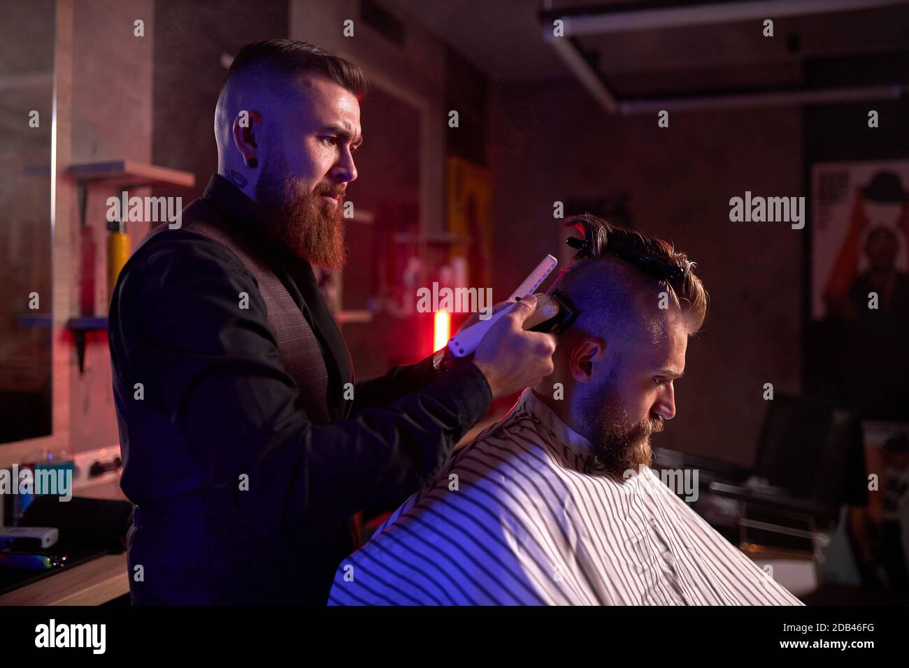 haircut at the hairdresser, in salon. barber male cuts the hair on the ...