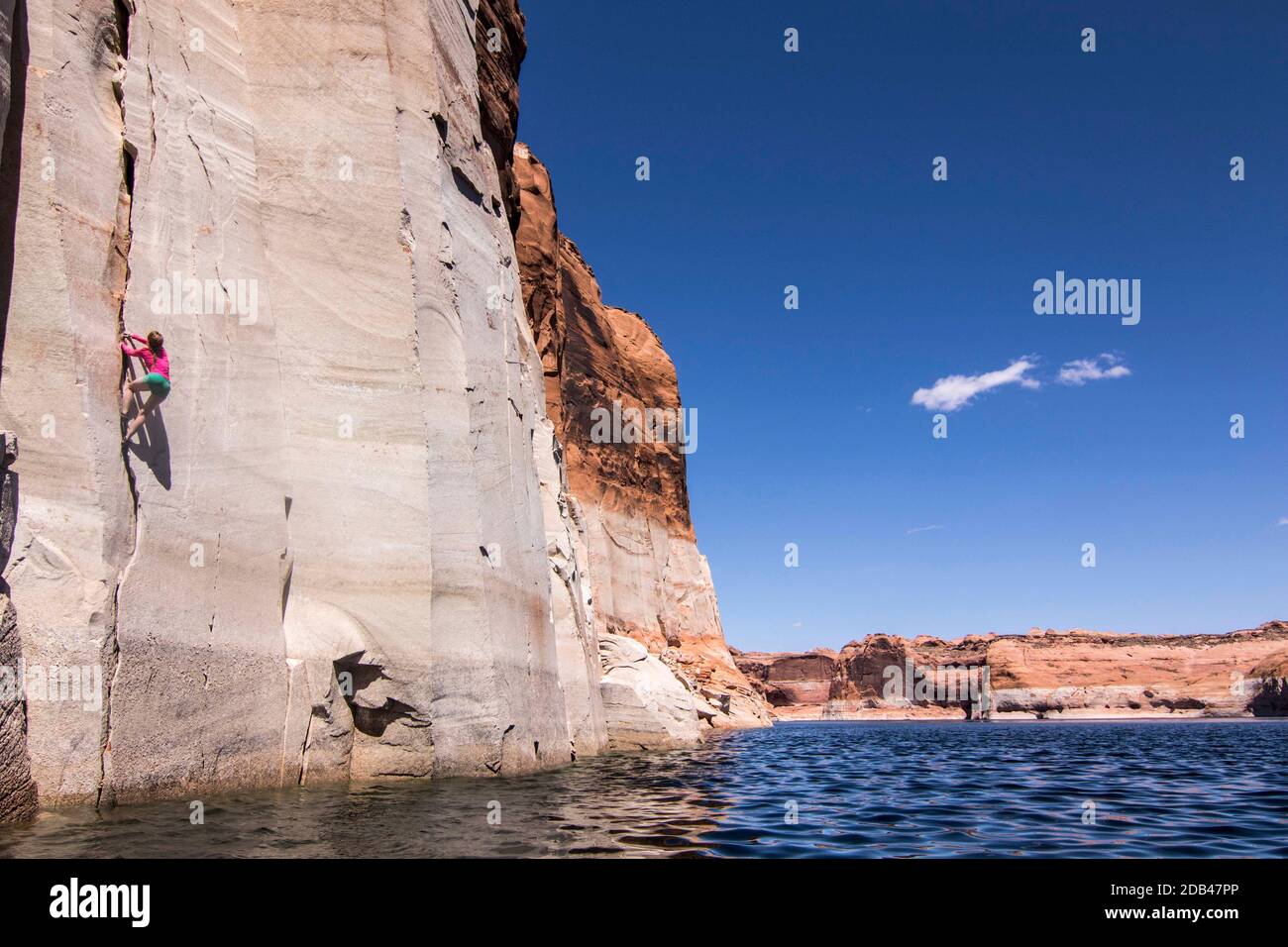 Woman rock climbing up cliff, Lake Powell, Utah, USA Stock Photo - Alamy