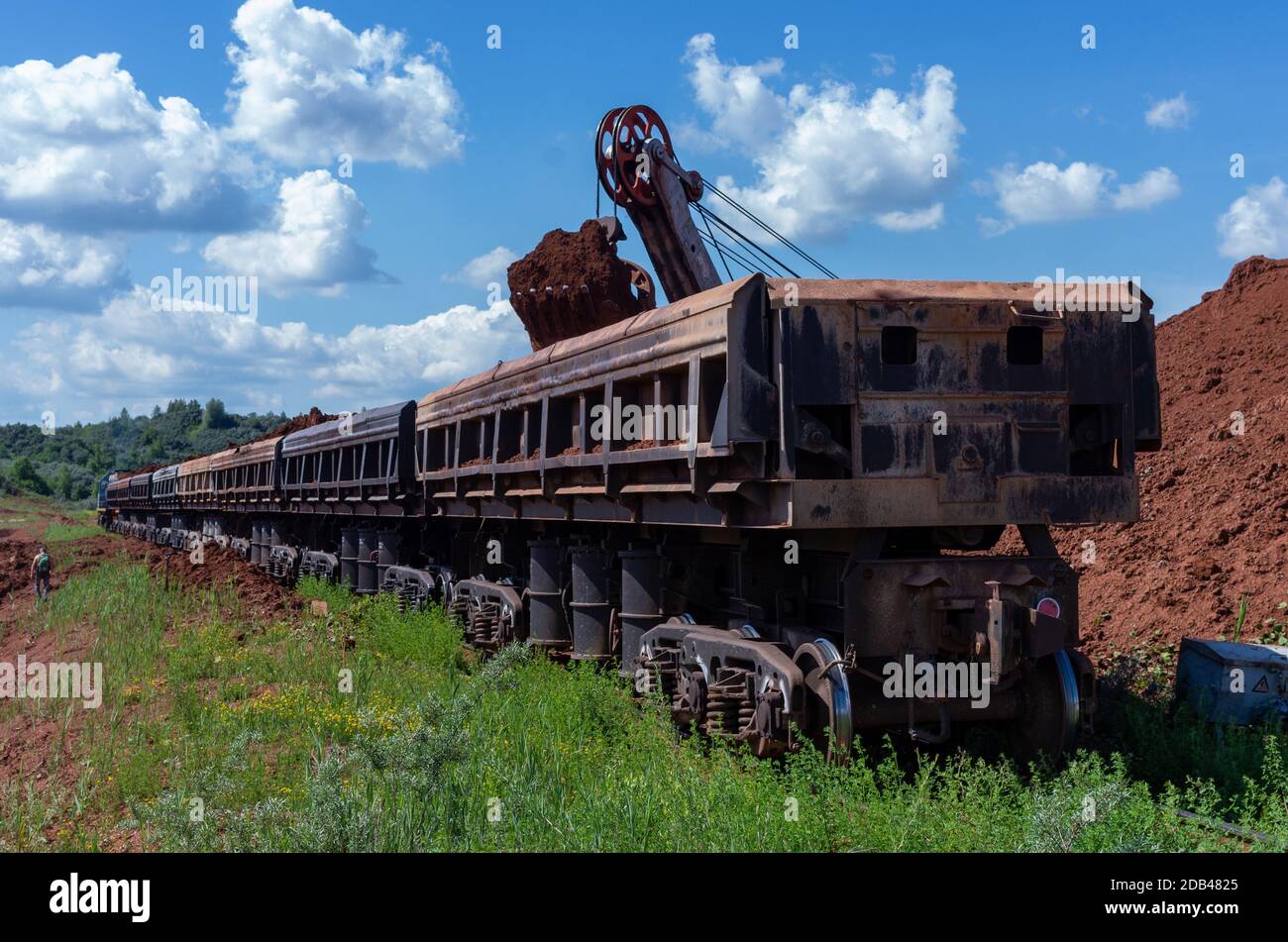 Excavator loading clay to the train on the opencast mining site Stock ...