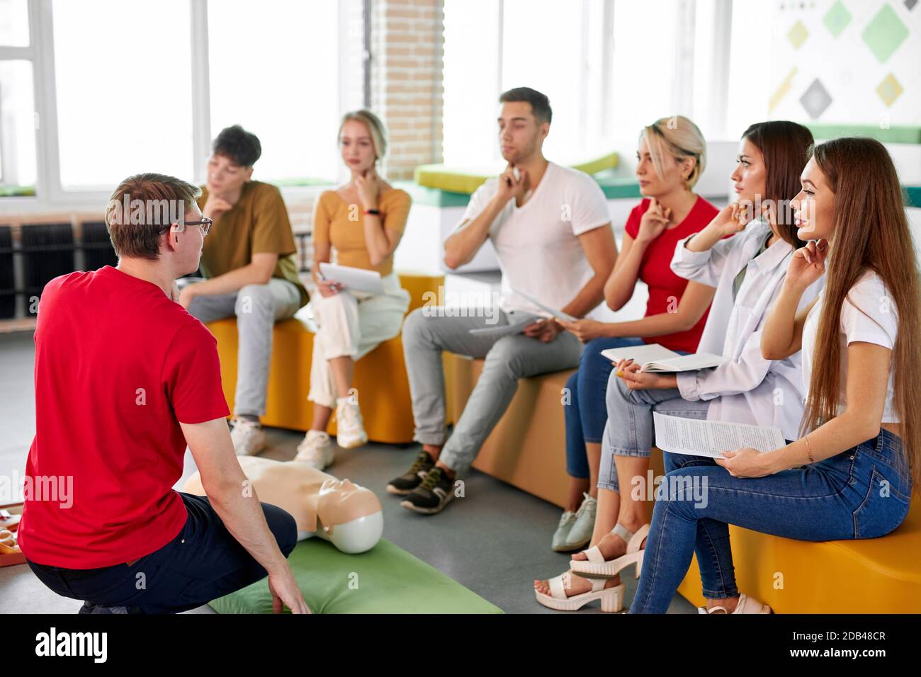 group of young diverse people practice first aid training by hand ...