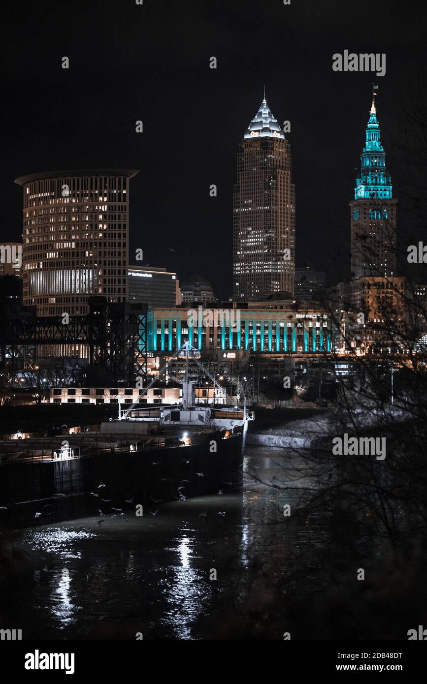 Cleveland ohio skyline at night with a ship on the cuyahoga river Stock ...