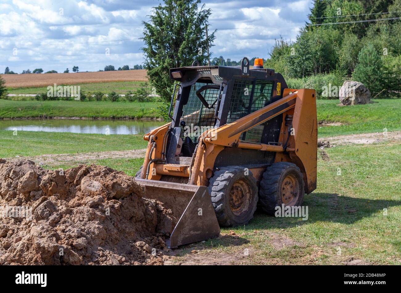 Mini excavator standing at construction field Stock Photo - Alamy