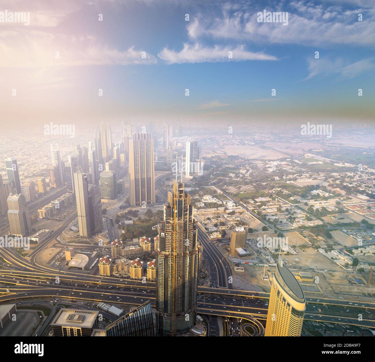 Construction of skyscrapers in Dubai city skyline, vintage nature ...