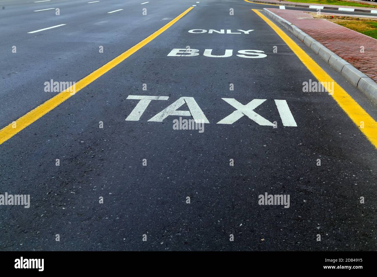 Bus and Taxi sign painted on street Stock Photo - Alamy