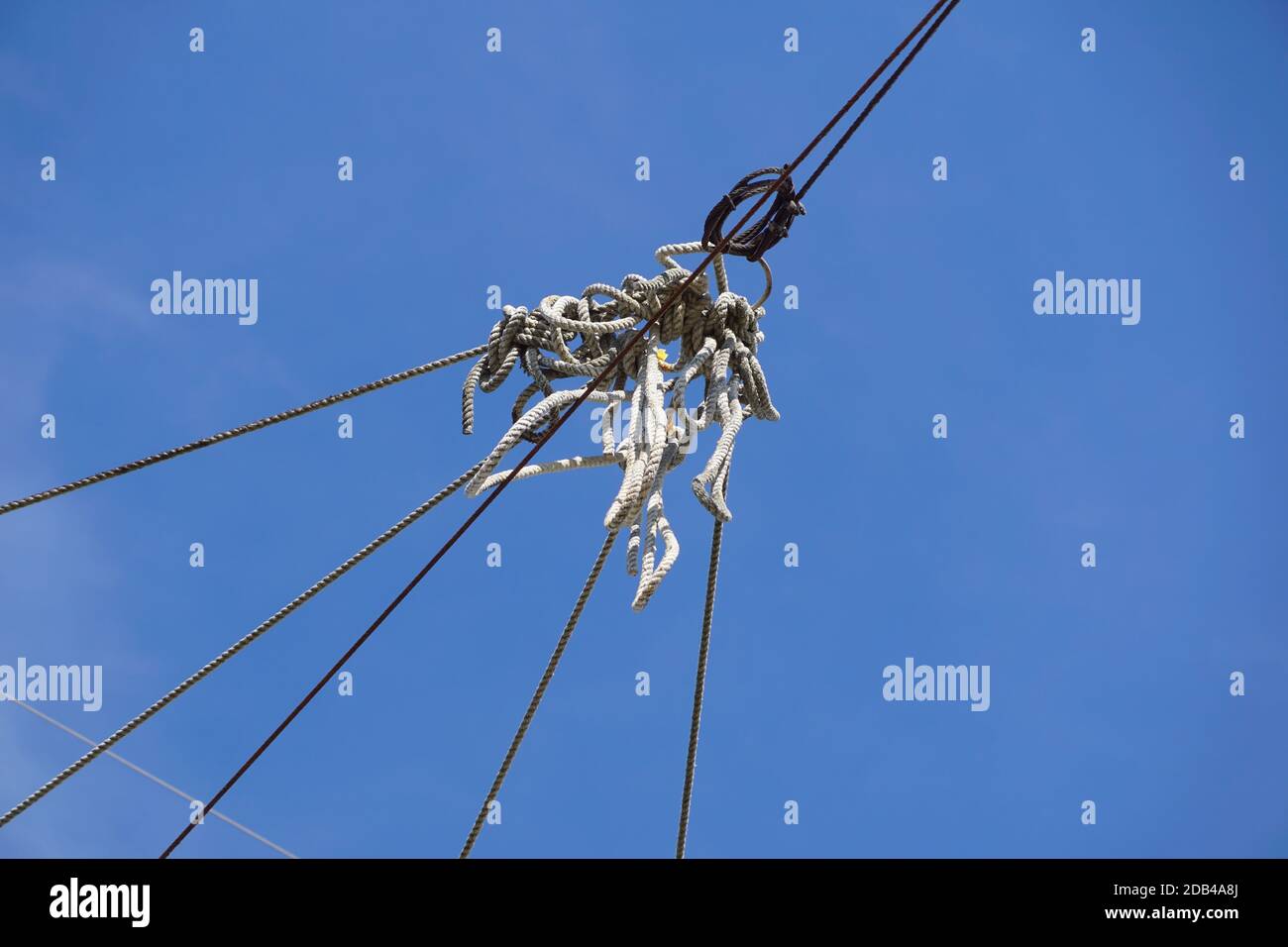 Three red ropes attached to a metal ring Stock Photo - Alamy