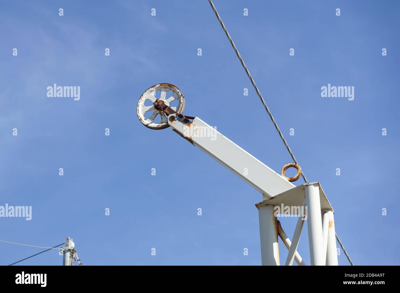 Steel pulley wheel with three steel cables looping around the pulley ...