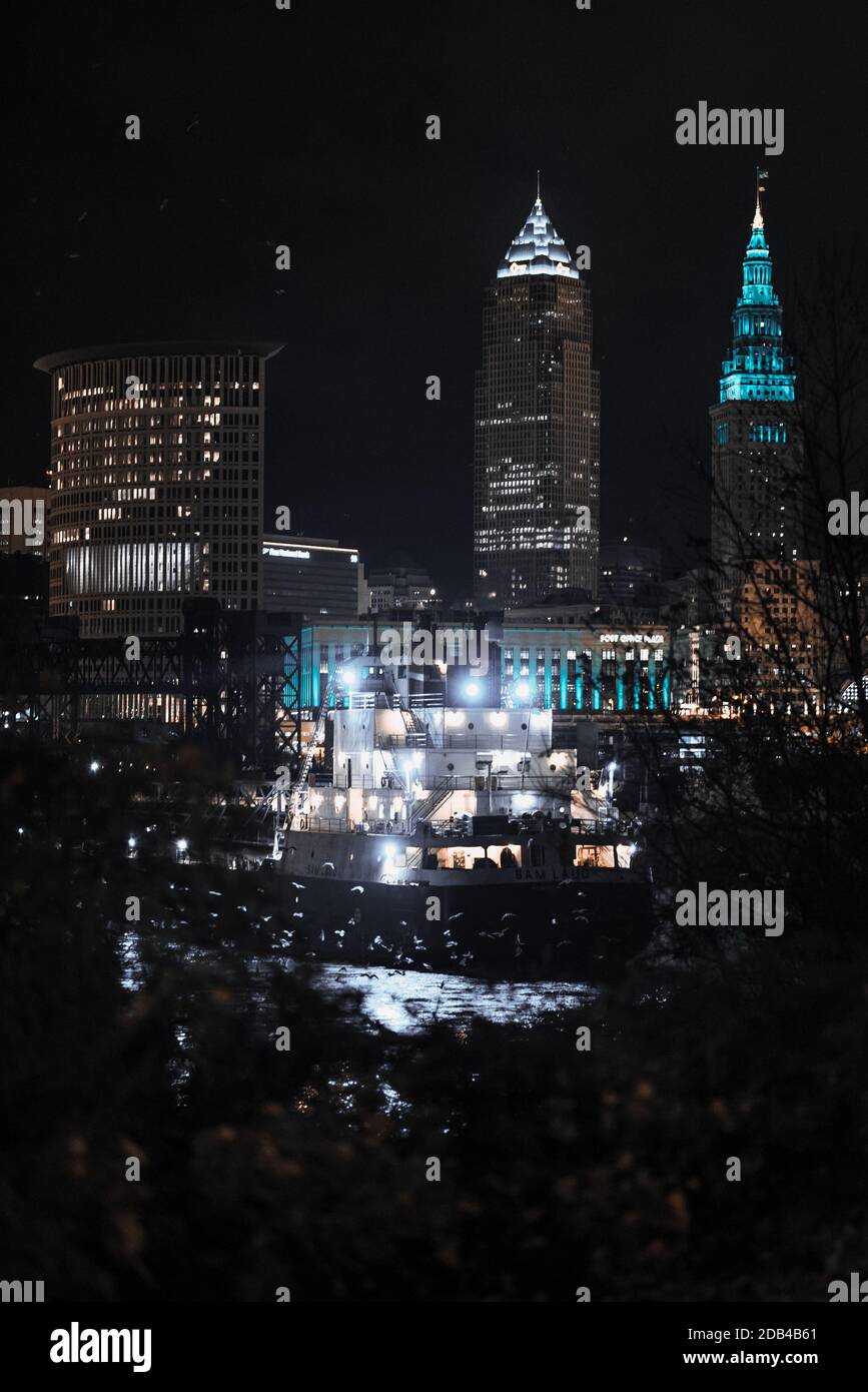Cleveland ohio skyline at night with a ship on the cuyahoga river Stock ...