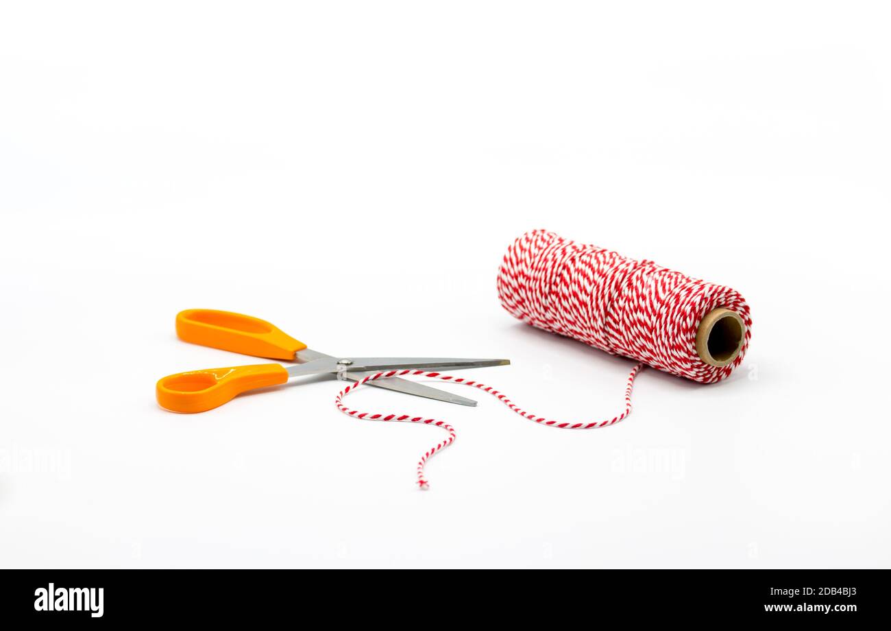 Orange scissors with rope on white background Stock Photo - Alamy