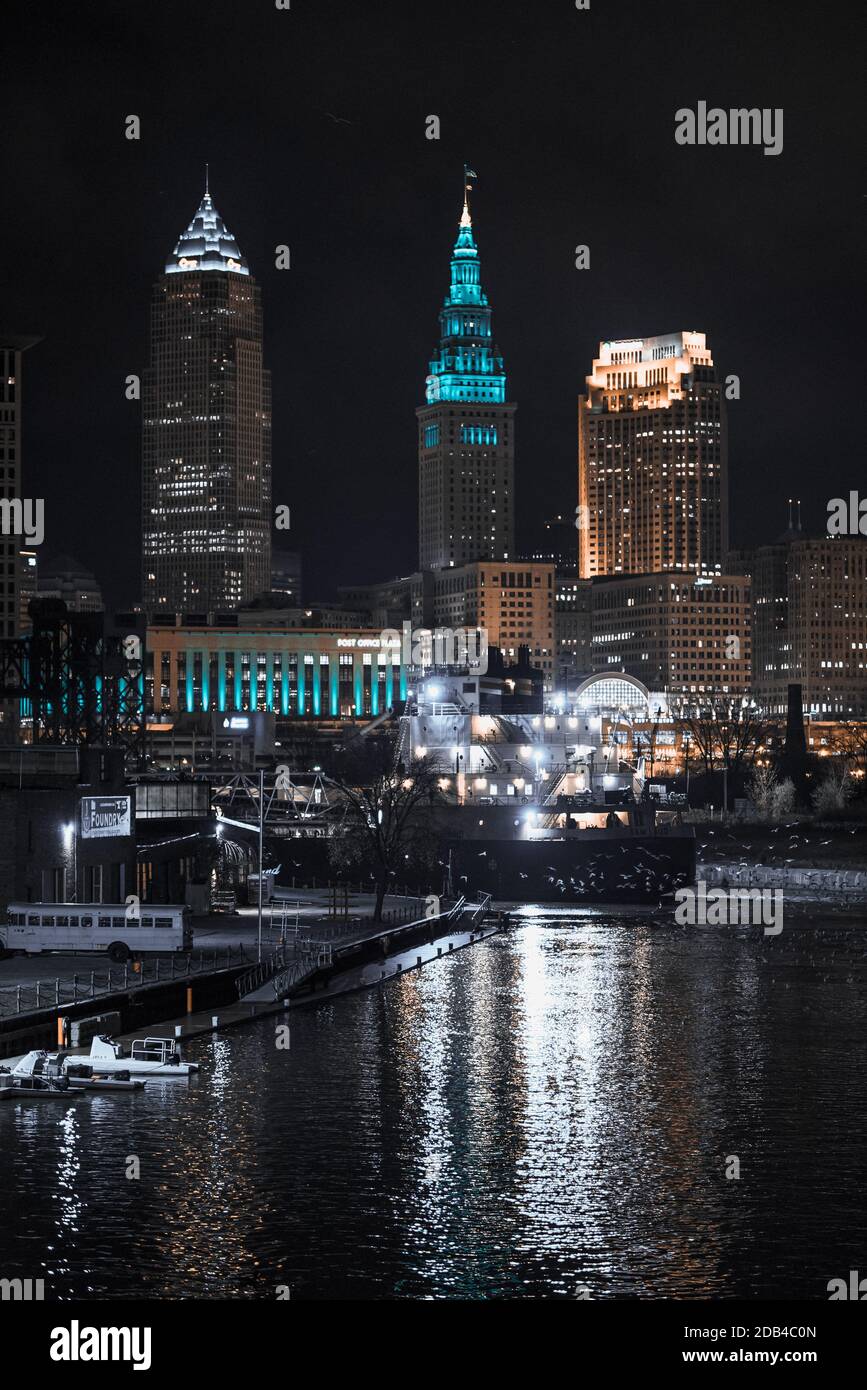 Cleveland ohio skyline at night with a ship on the cuyahoga river Stock ...