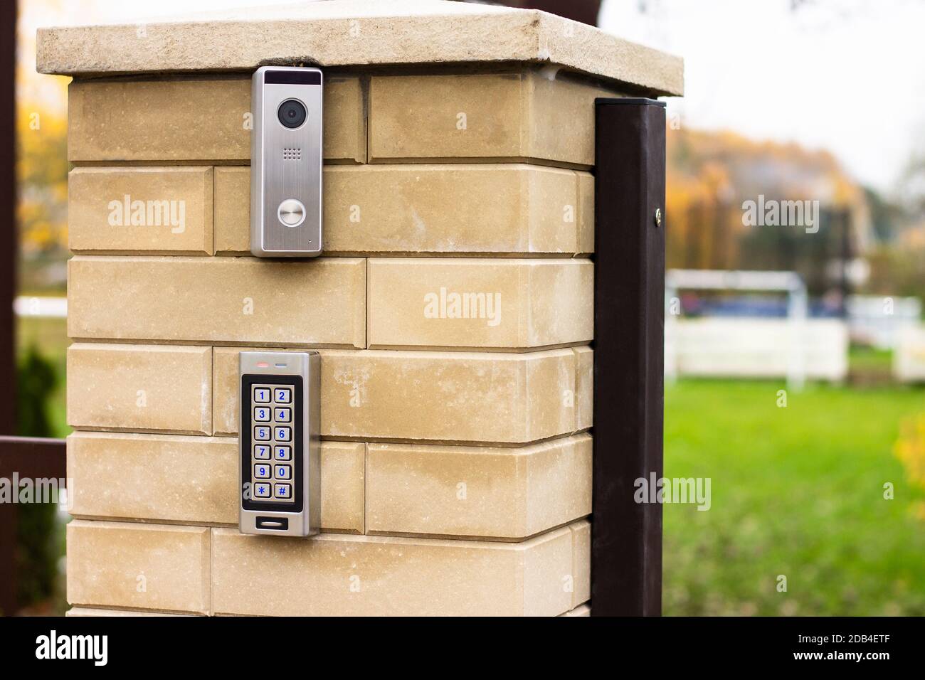 Silver intercom call panel with blue number buttons and a video camera ...
