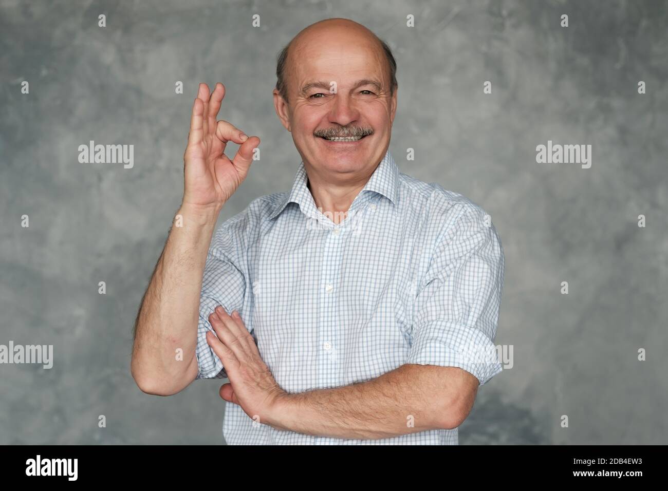 Senior man with mustache showing OK sign approving your choice Stock ...